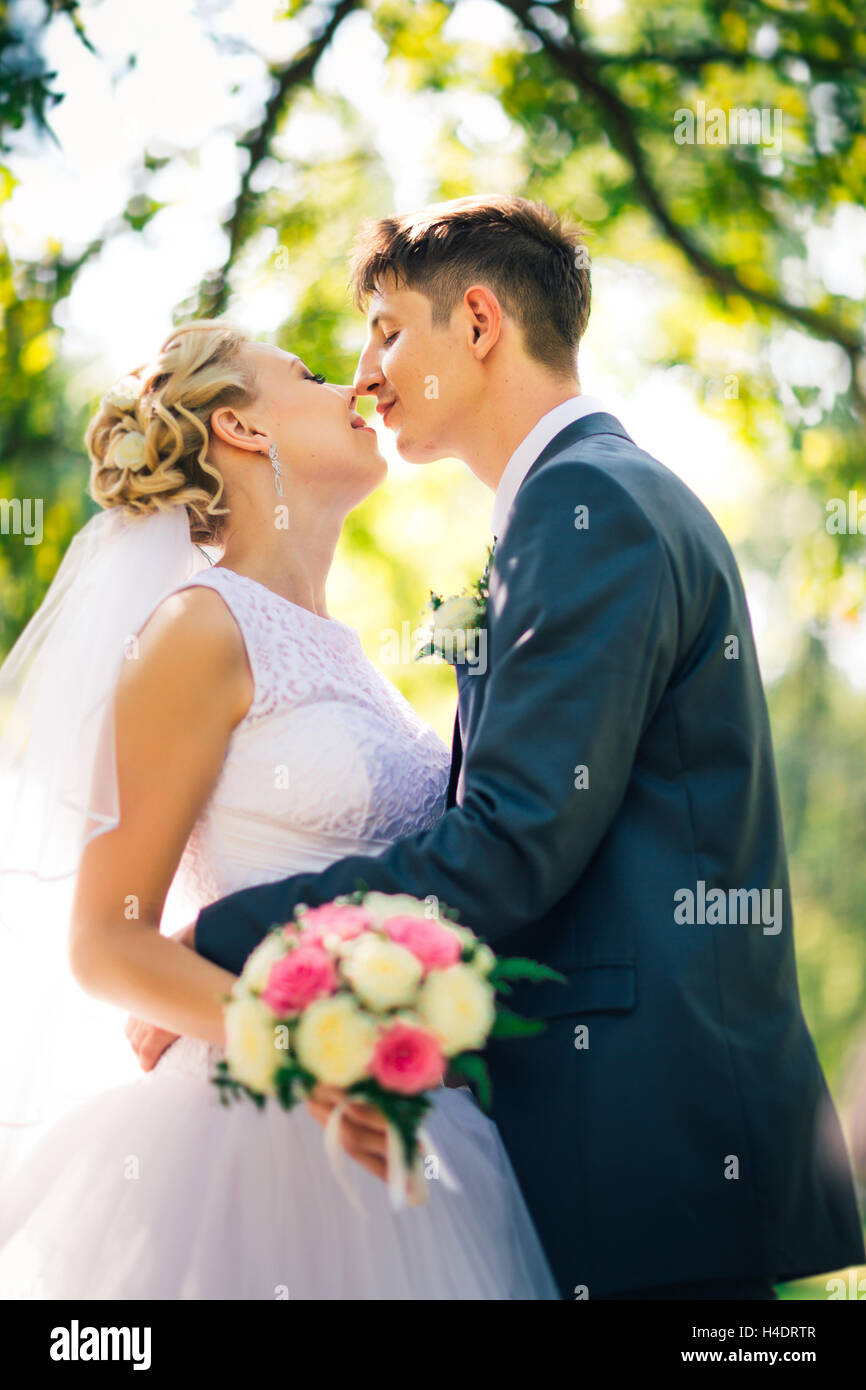 portrait the bride and groom on the background of the park alley Stock ...