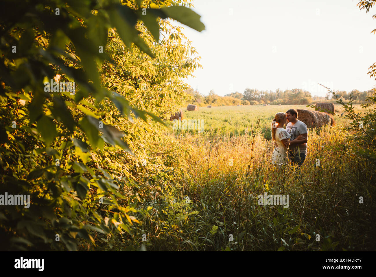 love story man and woman on the background of haystacks and sun Stock ...