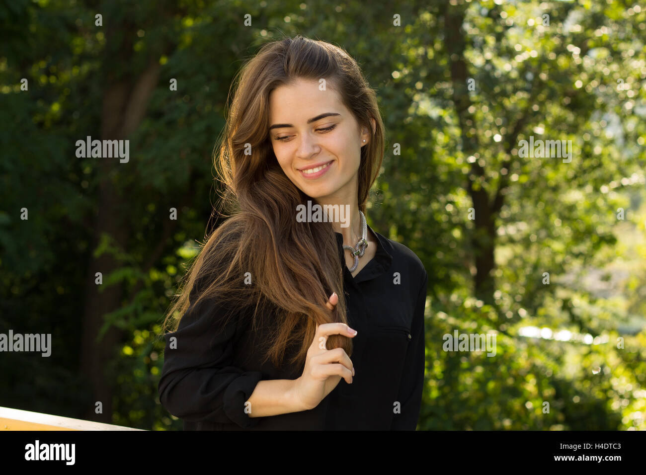 Young woman holding her hair Stock Photo - Alamy