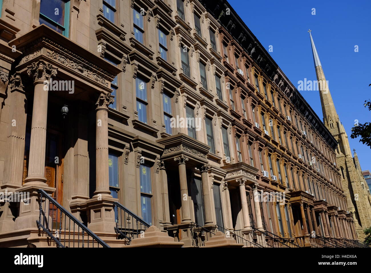 renovated classic brownstone apartment buildings with Ephesus Church of ...