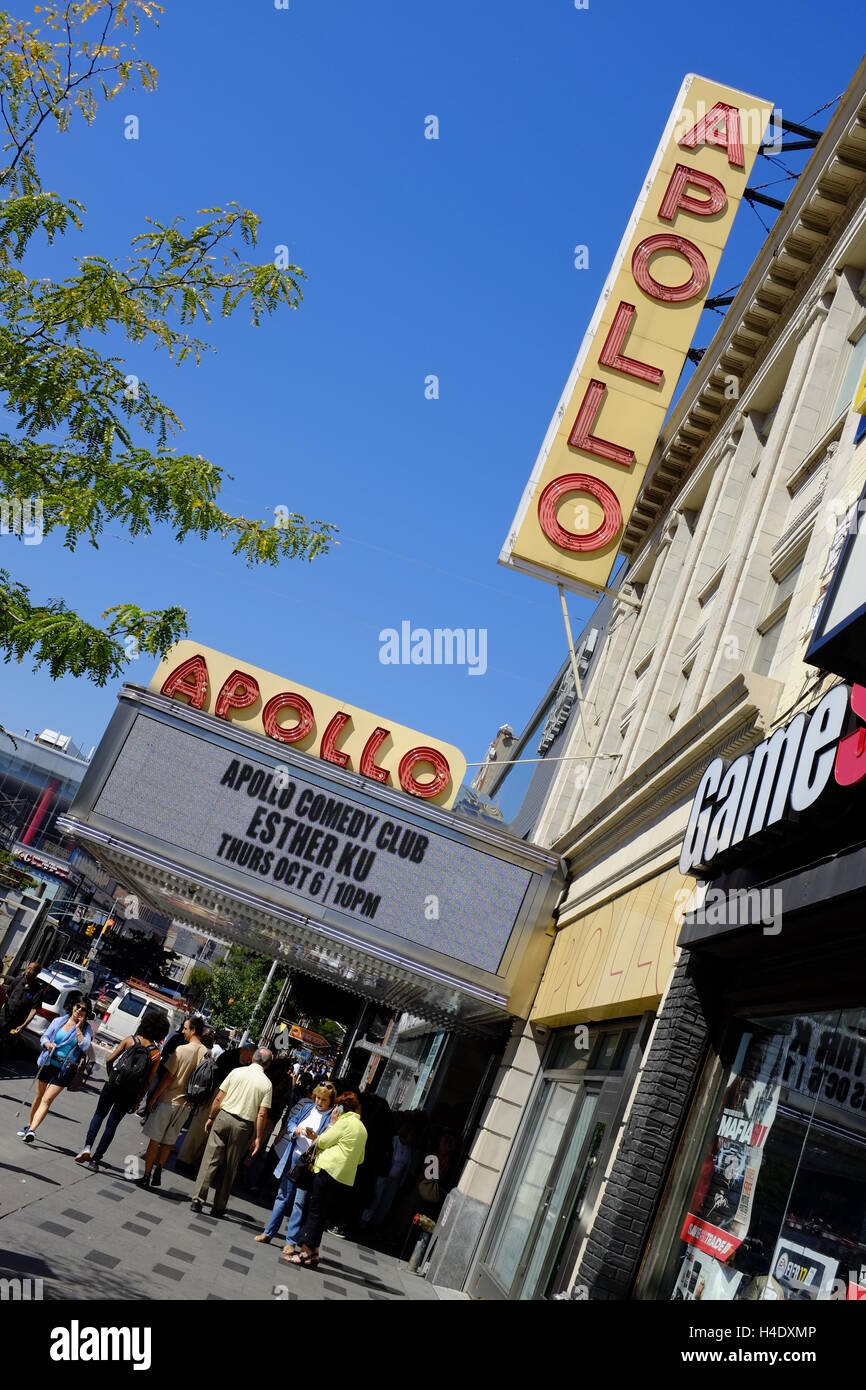 Pedestrians on 125th street with sign of Apollo Theater on the entrance ...