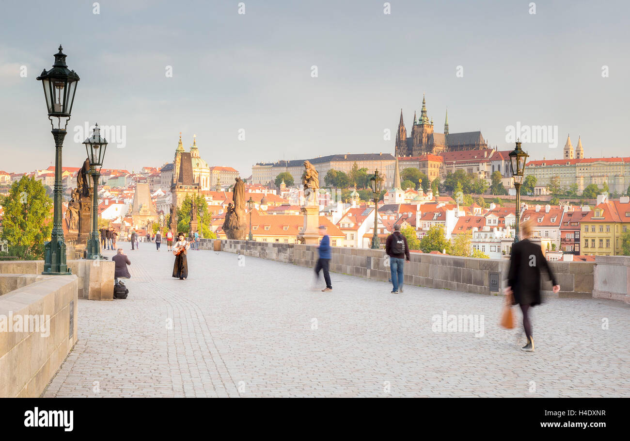 A female minstrel plays on Karlûv Most, Charles Bridge, as the sun ...