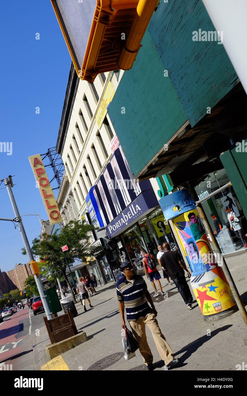 Pedestrian on 125th street with the sign of Apollo Theater in the ...