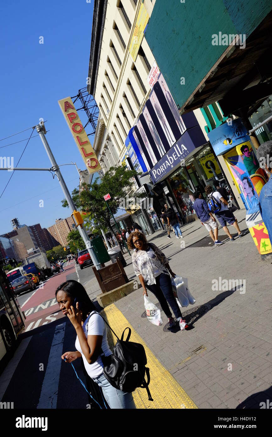 Pedestrian on 125th street with the sign of Apollo Theater in the ...