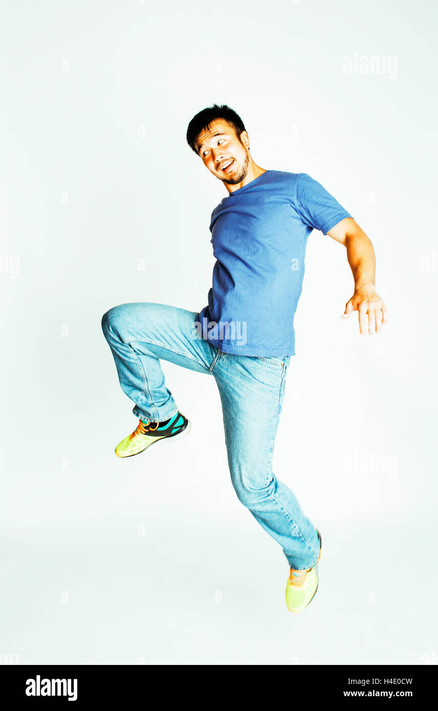 young pretty asian man jumping cheerful against white background ...