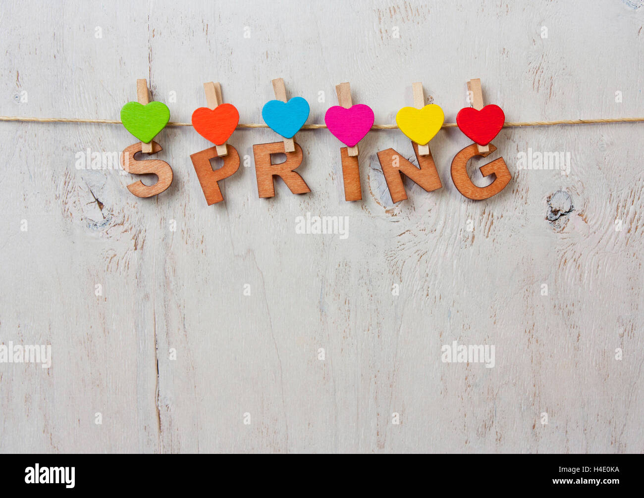 word spring and colored hearts on a white background old wooden Stock ...