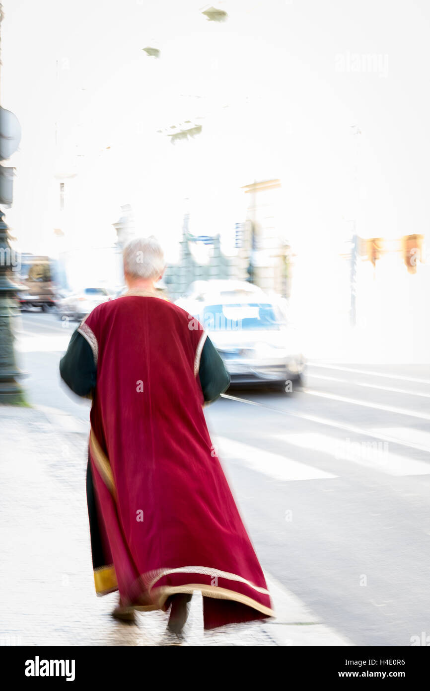 Good King Wenceslas? Man in red cloak strides down the street in Prague ...