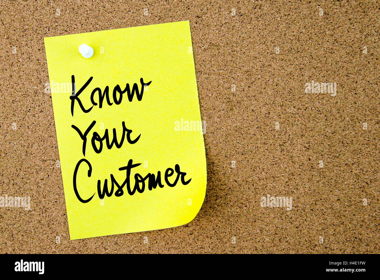 Know Your Customer text written on yellow paper note pinned on cork ...