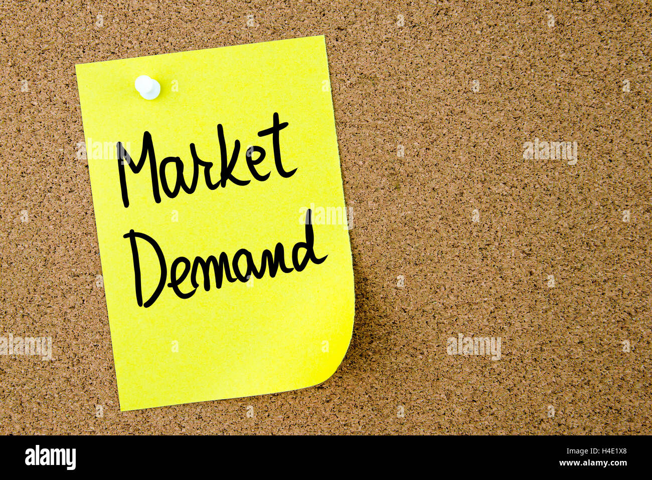 Market Demand text written on yellow paper note pinned on cork board ...