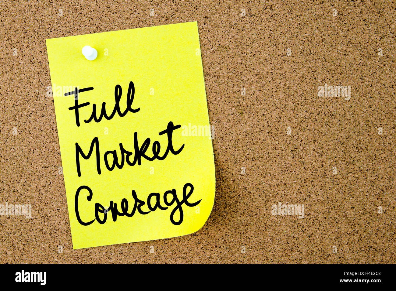 Full Market Coverage text written on yellow paper note pinned on cork ...