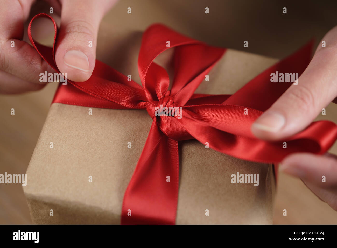 packing gift box with red ribbon Stock Photo - Alamy