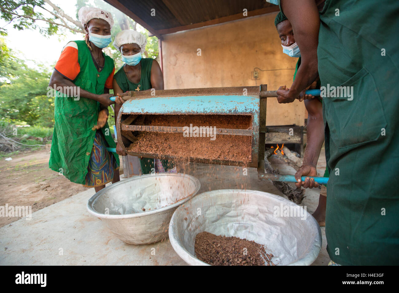 Employees process shea nuts into shea butter at a fair trade production ...