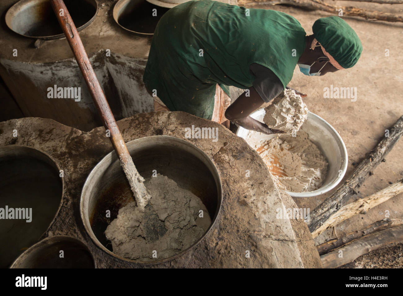 An employee processes shea butter into oil at a fair trade production ...
