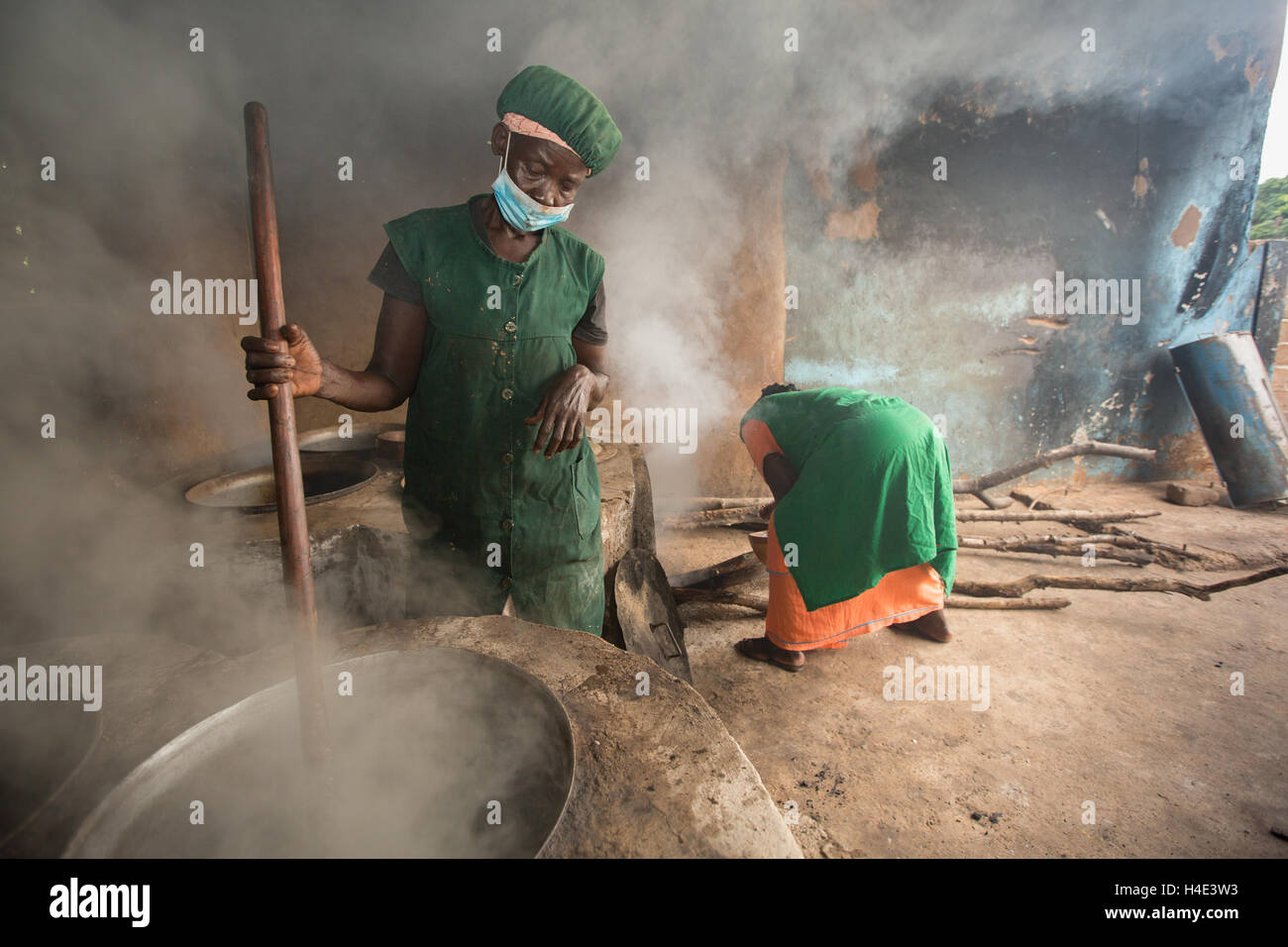 An employee processes shea butter into oil at a fair trade production ...