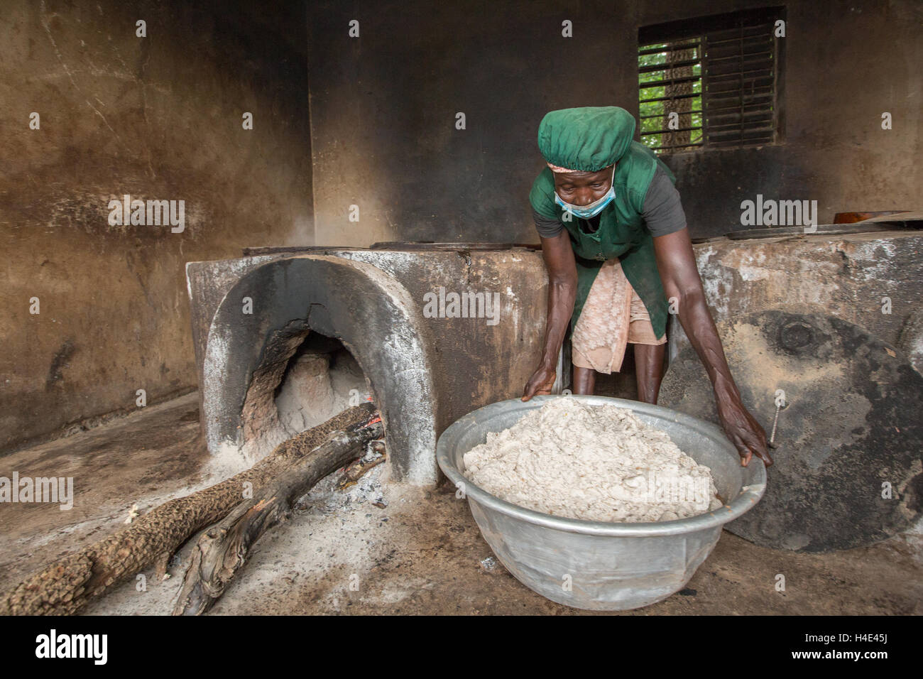 An employee processes shea butter into oil at a fair trade production ...