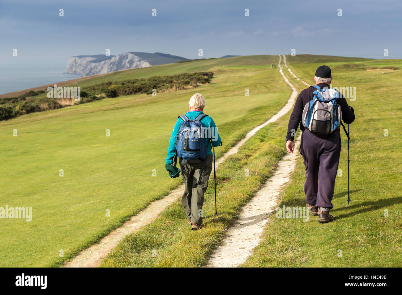 Two people walking on chalk downlands, Compton Down, Isle of Wight, UK ...