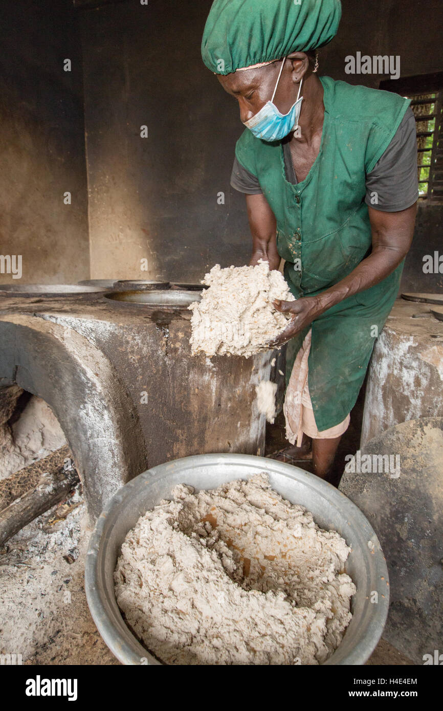 An employee processes shea butter into oil at a fair trade production ...