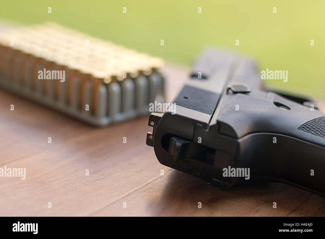 Gun with bullets. Handgun box with new ammunition Stock Photo - Alamy