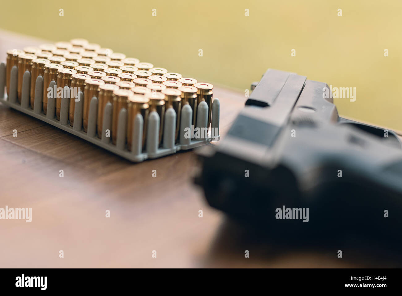 Gun with bullets. Handgun box with new ammunition Stock Photo - Alamy