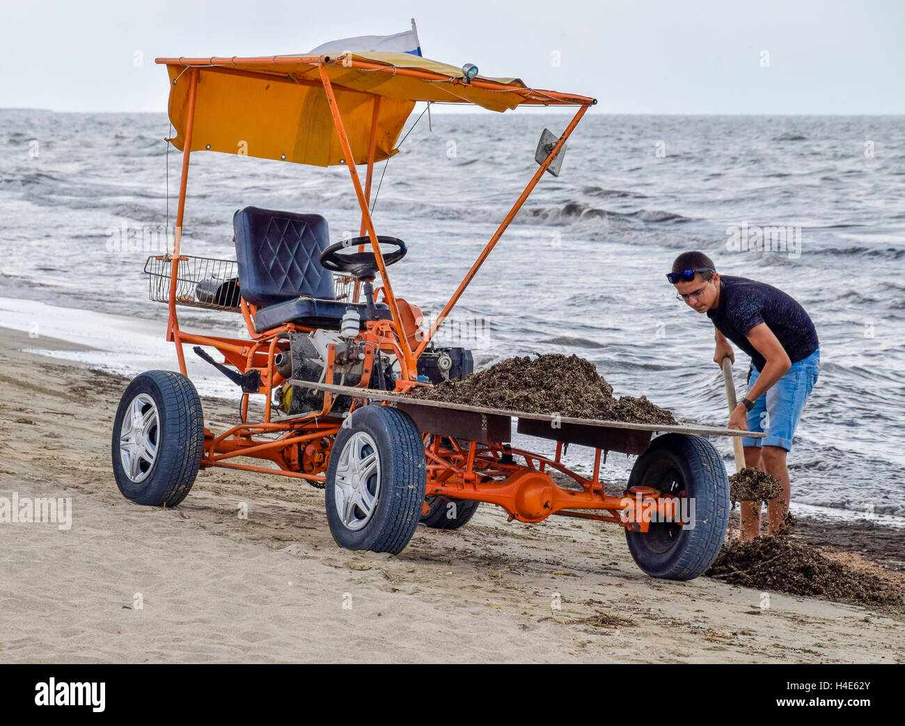 The car for garbage collection from the beach. Cleaning on the beach ...