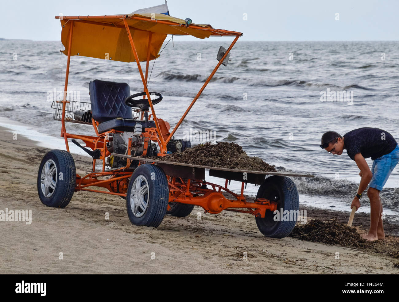 The car for garbage collection from the beach. Cleaning on the beach ...
