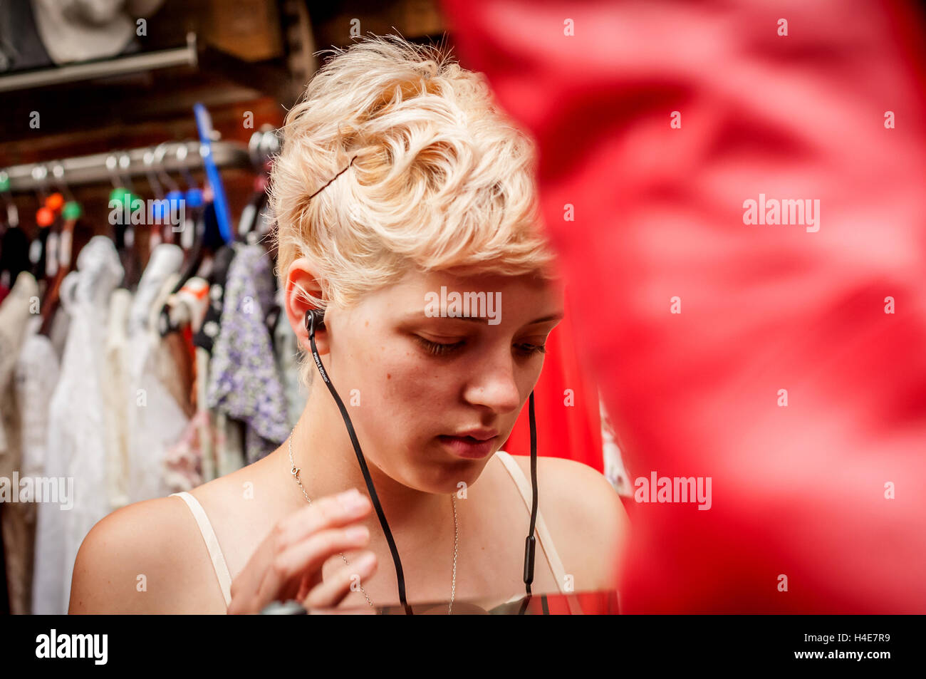 Model wearing in-ear buds, or headphones, to listen to their music ...