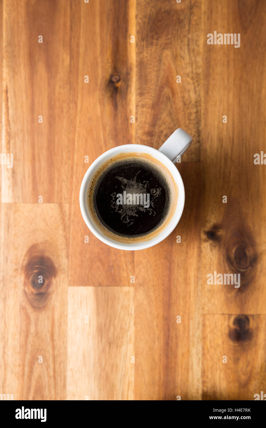 Cup of coffee on wooden table. Top view Stock Photo - Alamy