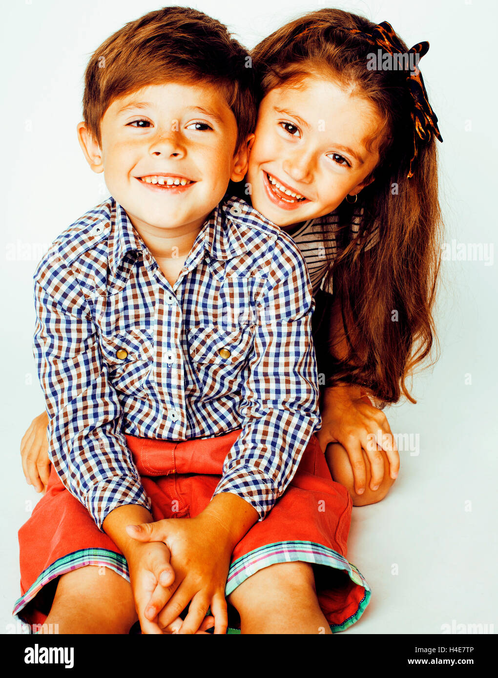 little cute boy and girl hugging playing on white background, ha Stock Photo - Alamy