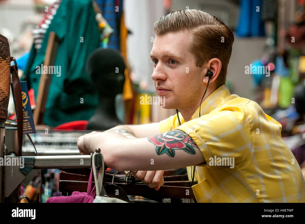 Model wearing in-ear buds, or headphones, to listen to their music ...