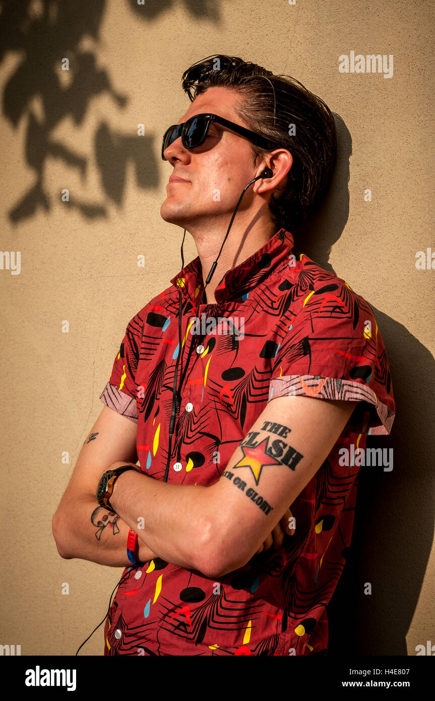 Model wearing in-ear buds, or headphones, to listen to their music ...