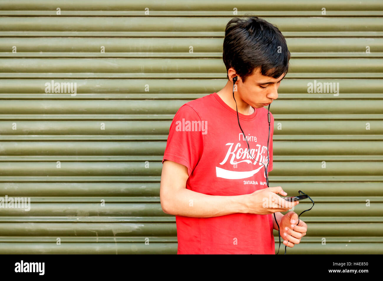 Model wearing in-ear buds, or headphones, to listen to their music ...