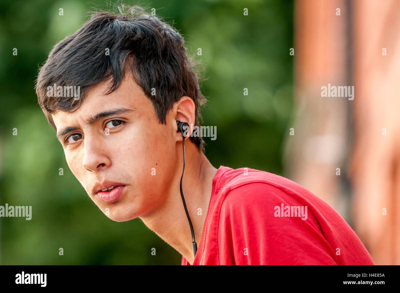 Model wearing in-ear buds, or headphones, to listen to their music ...