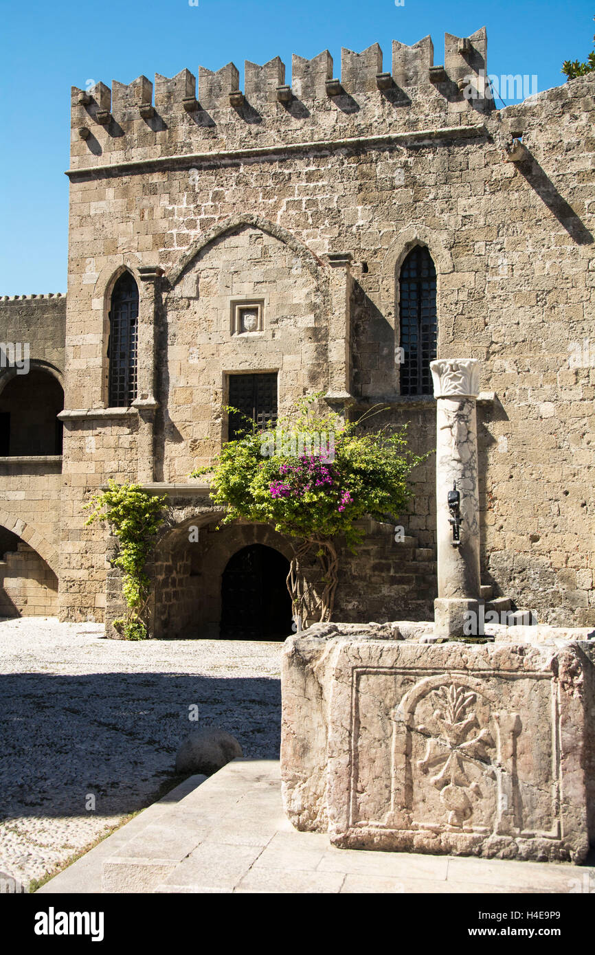 Rhodes, old hospital with well Stock Photo - Alamy