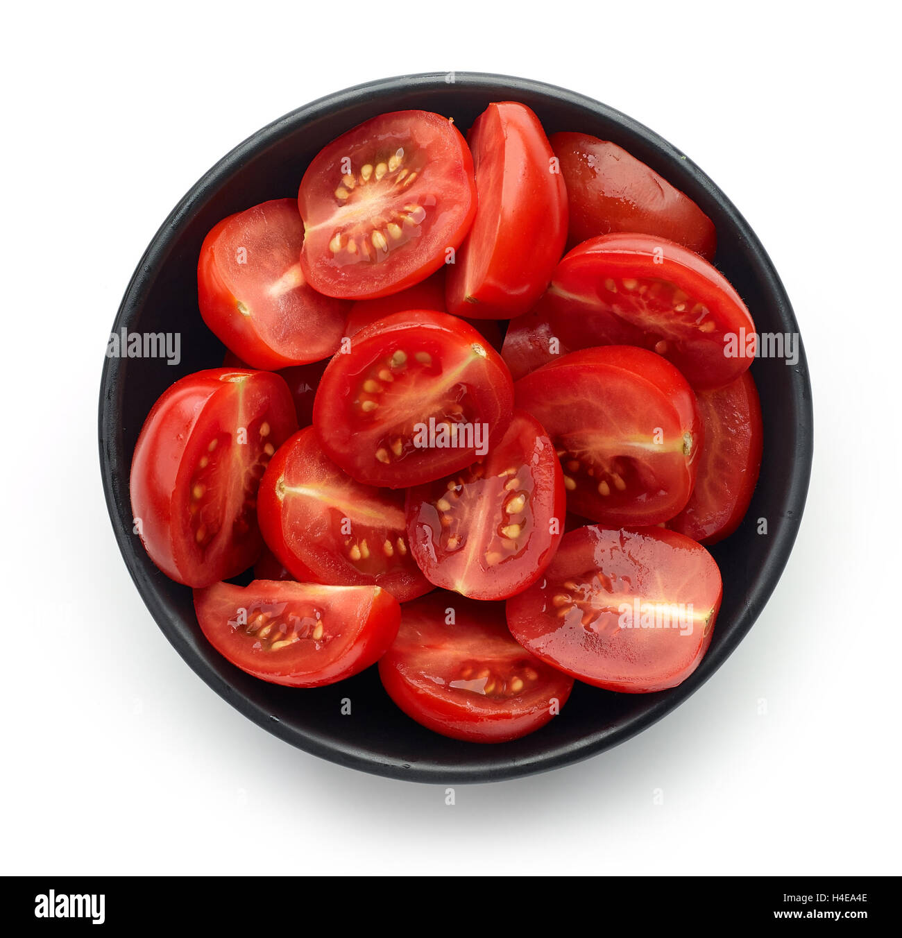 Black bowl of fresh cherry tomato lobes isolated on white background ...