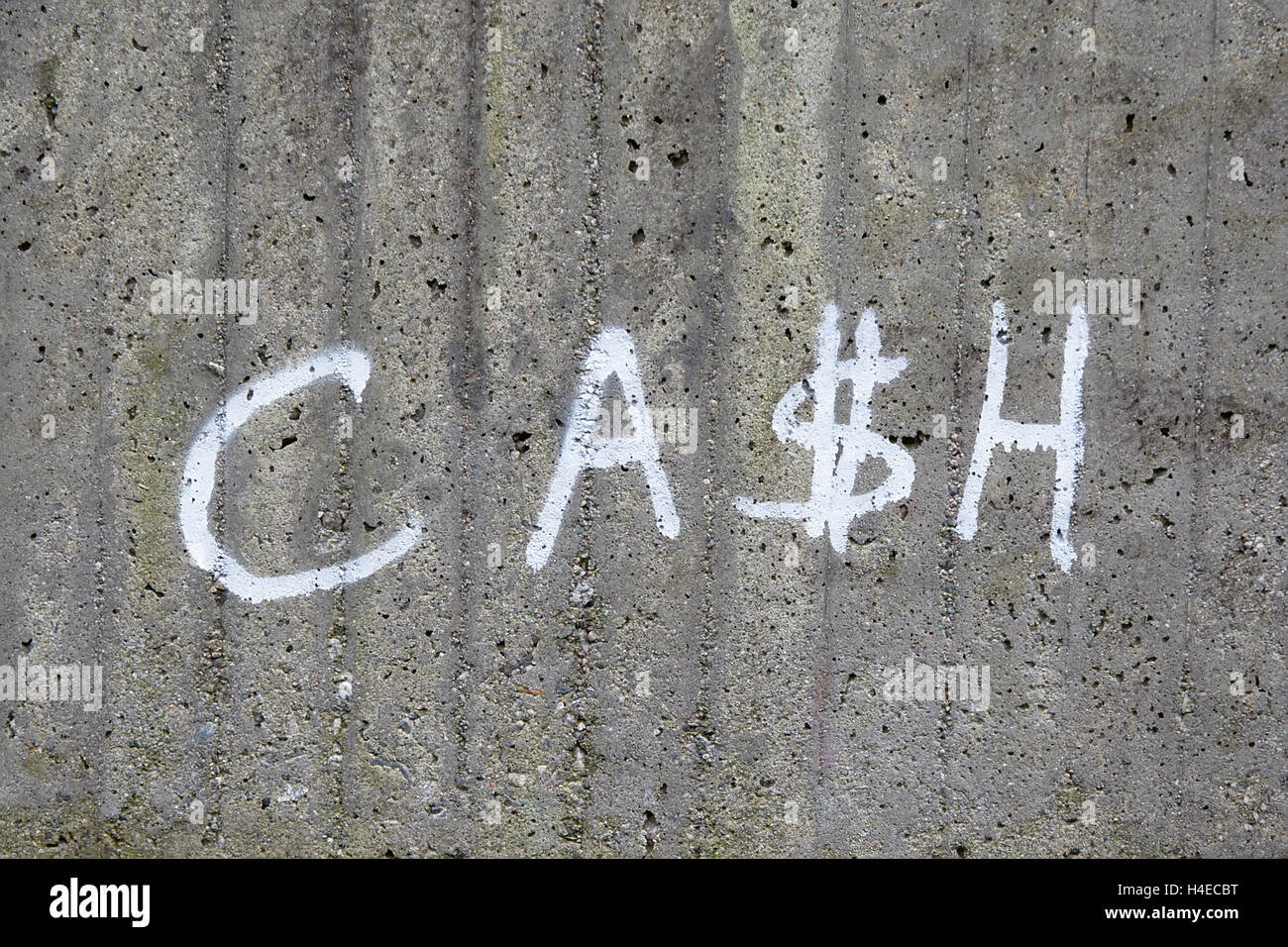 'Cash' white graffitiy on grey concrete background Stock Photo - Alamy