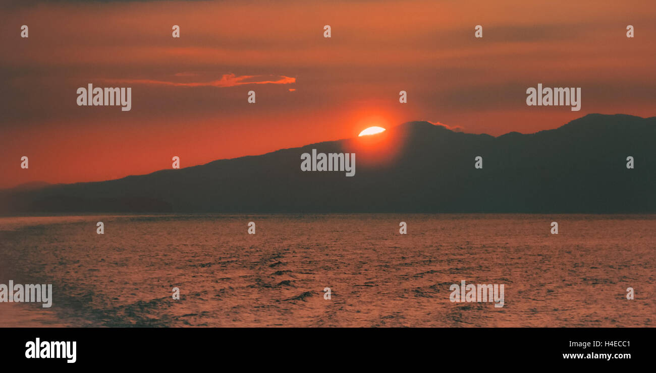 Sunset scene in Trinidad and Tobago Caribbean sea at dusk sun hiding ...