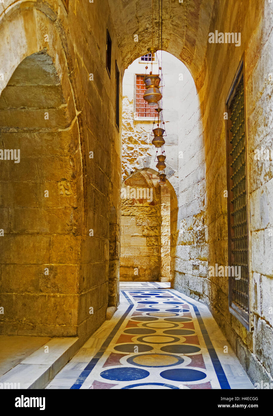 The narrow hall, decorated with the colorful stone tiles on the floor ...