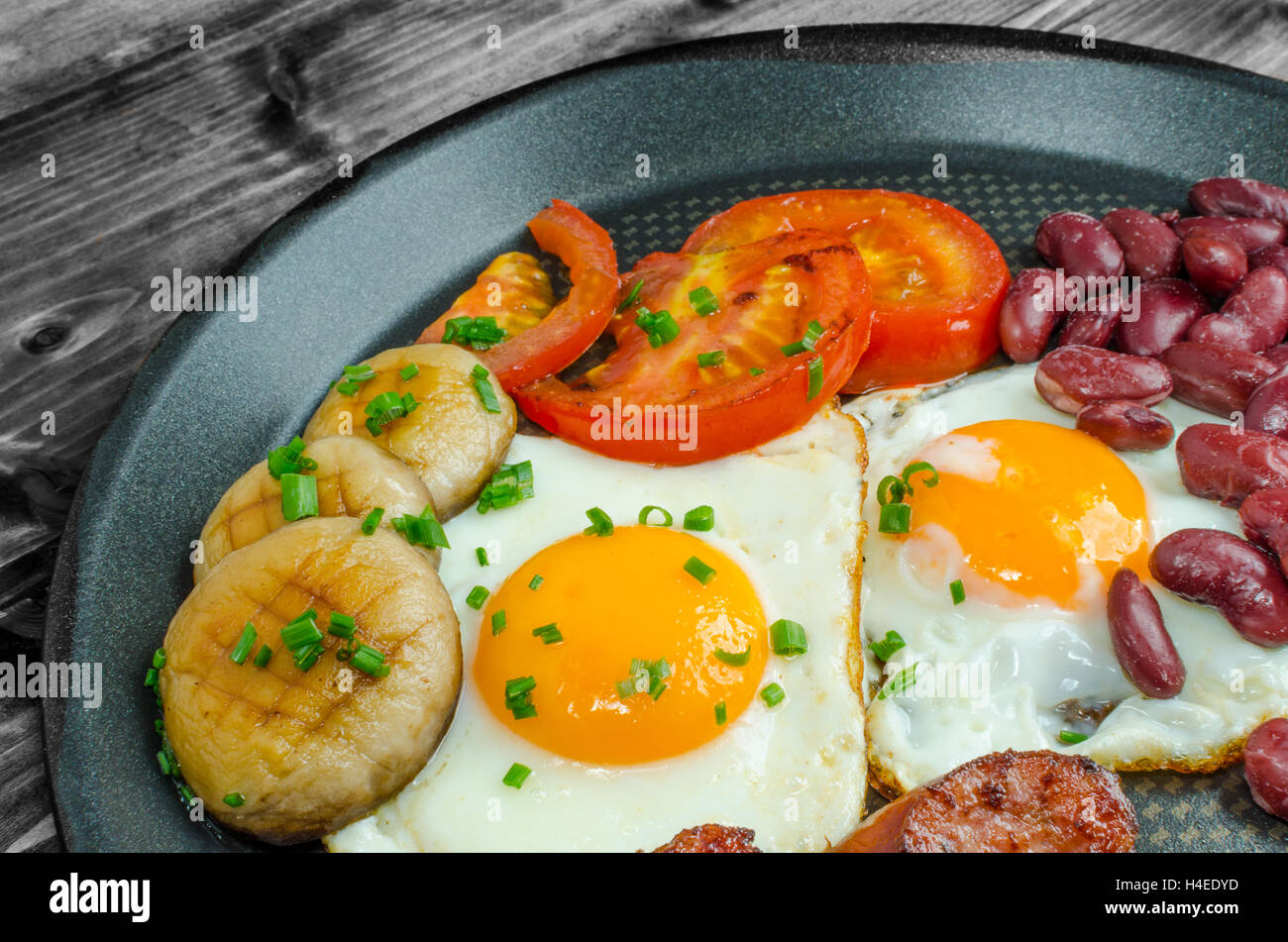 English breakfast on frying pan and wood table Stock Photo - Alamy