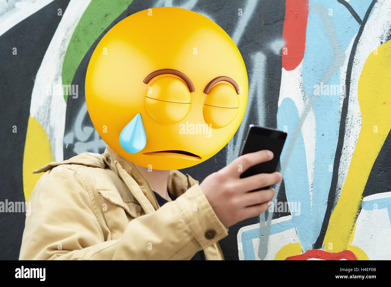 emoji head man using a smartphone. Emoji concept Stock Photo - Alamy