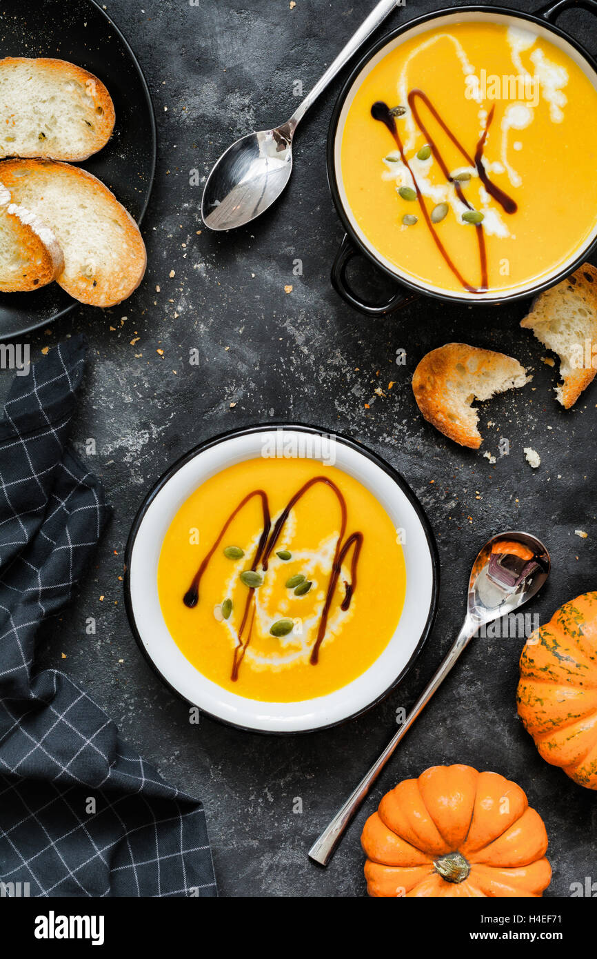 Pumpkin cream soup garnished with heavy cream, pumpkin seeds and ...