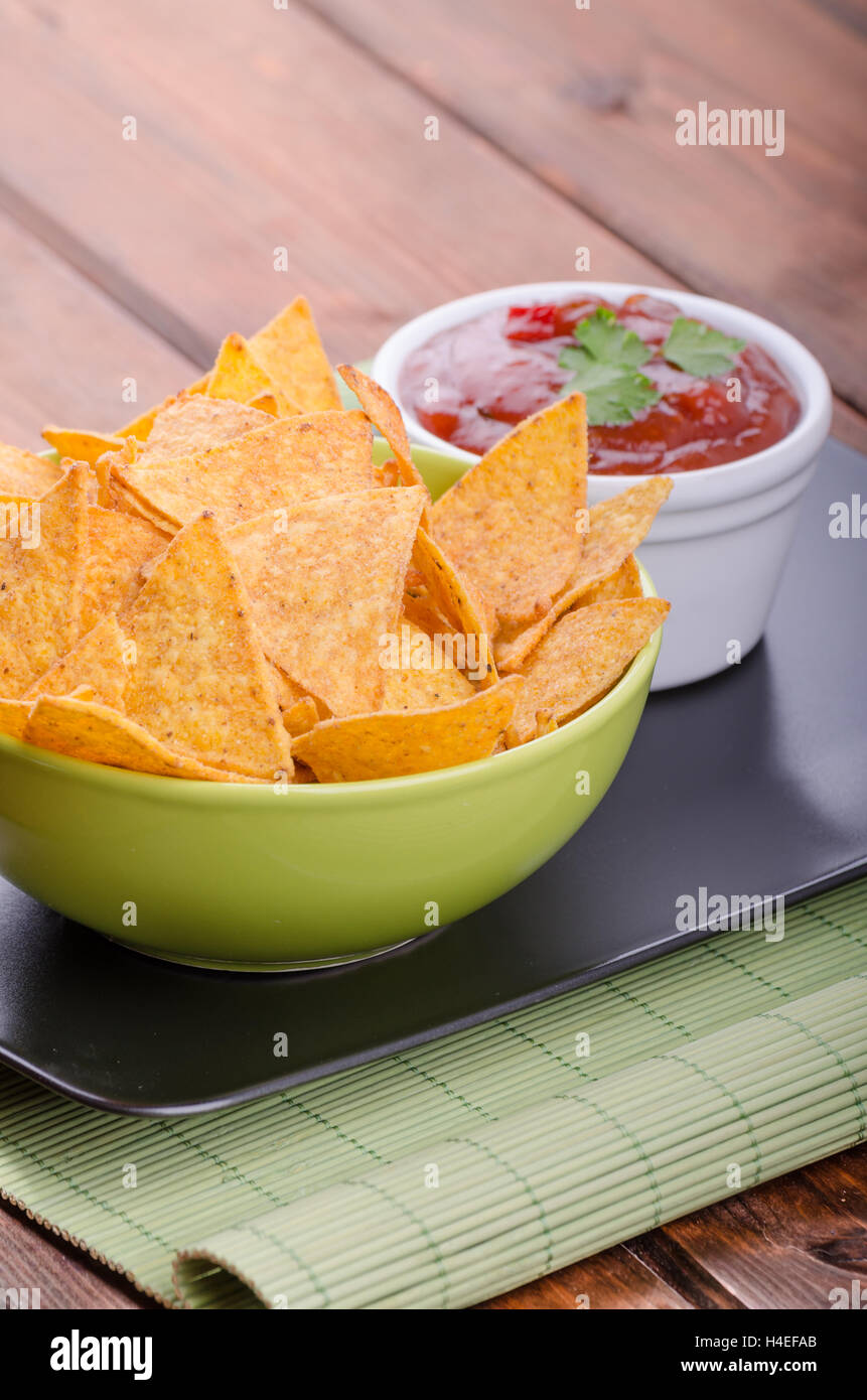 Tortilla chips with spicy tomato salsa with jalapeno Stock Photo - Alamy