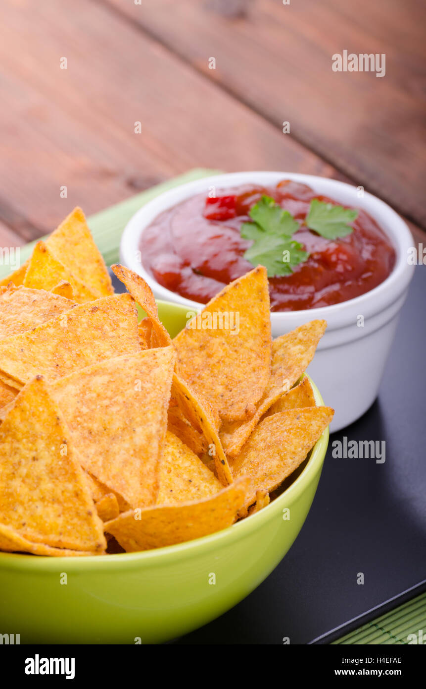 Tortilla chips with spicy tomato salsa with jalapeno Stock Photo - Alamy