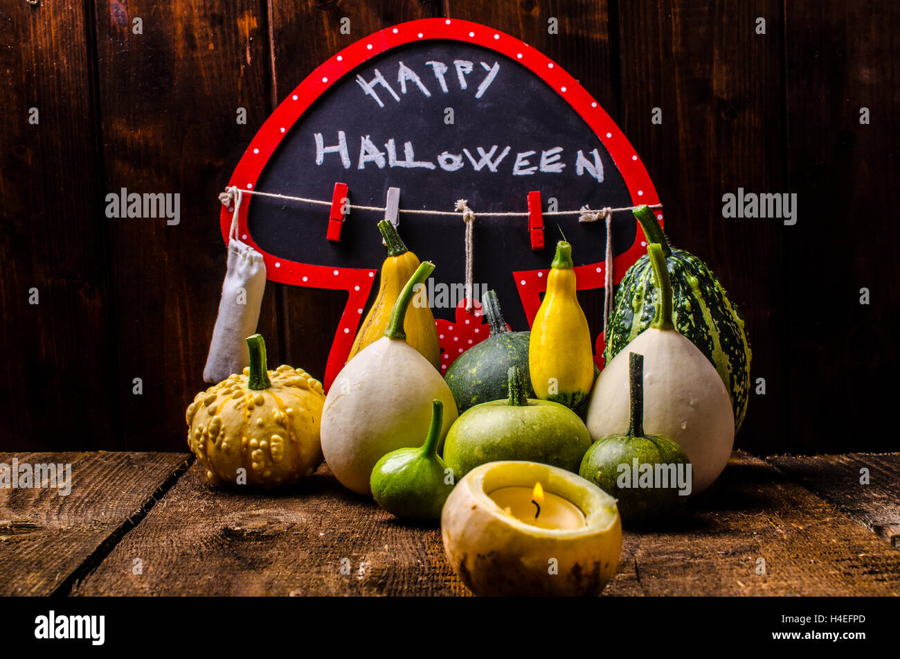 Halloween still life of pumpkins, inscription, shadows on wood Stock ...