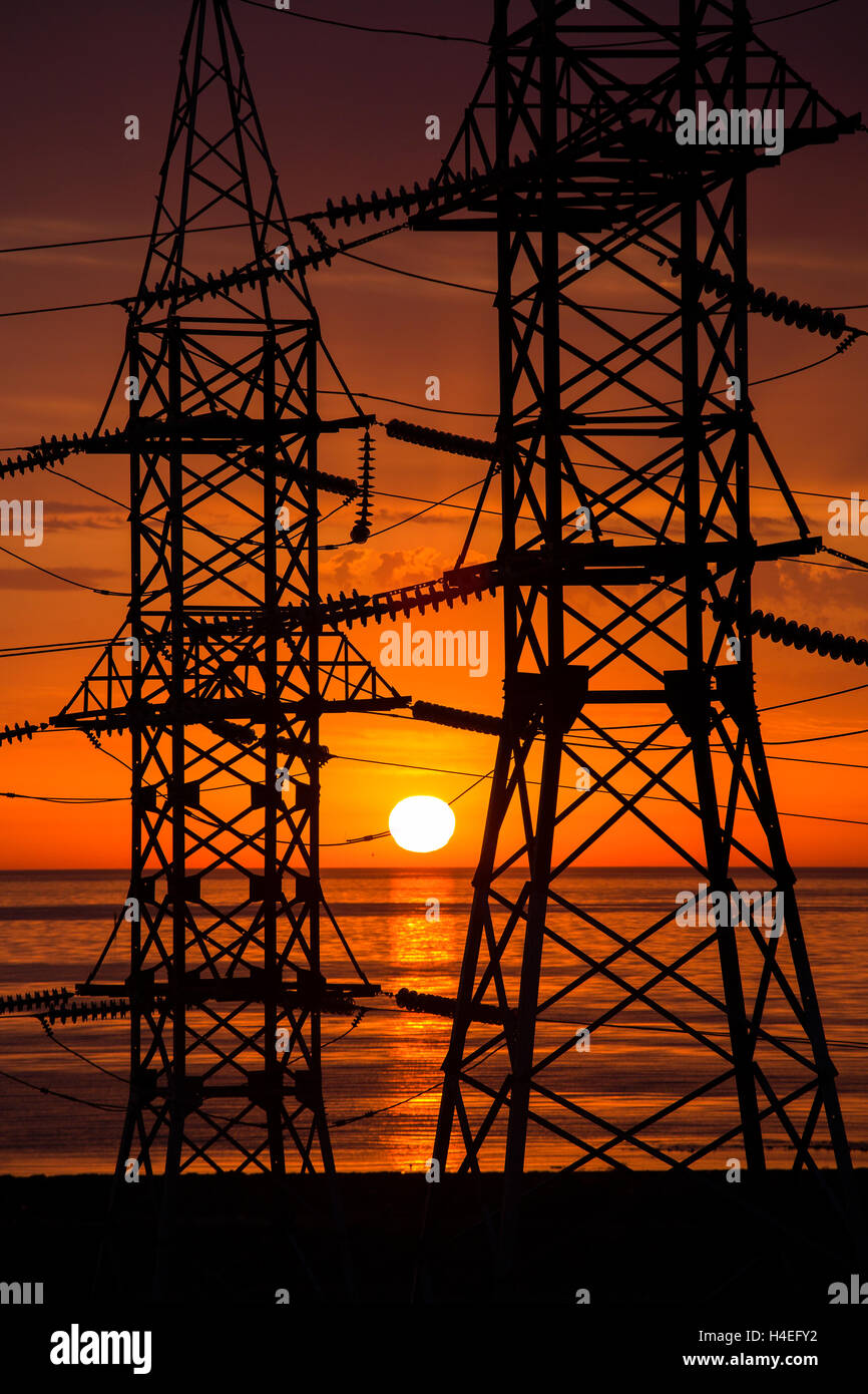Power lines on a background of red sunrise light Stock Photo - Alamy