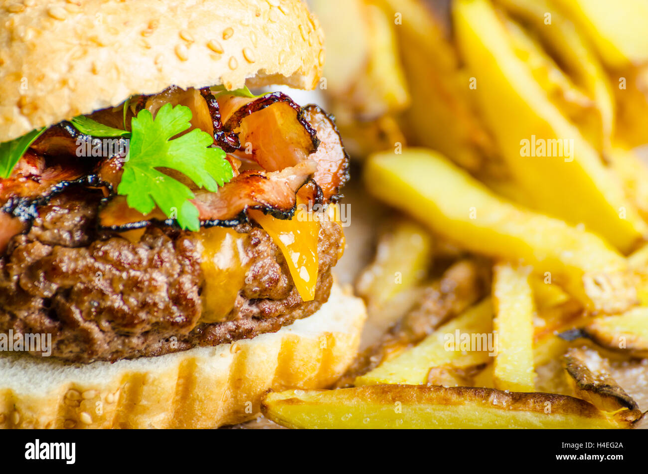 Homemade chilli burger with home spicy fries on wood board Stock Photo ...