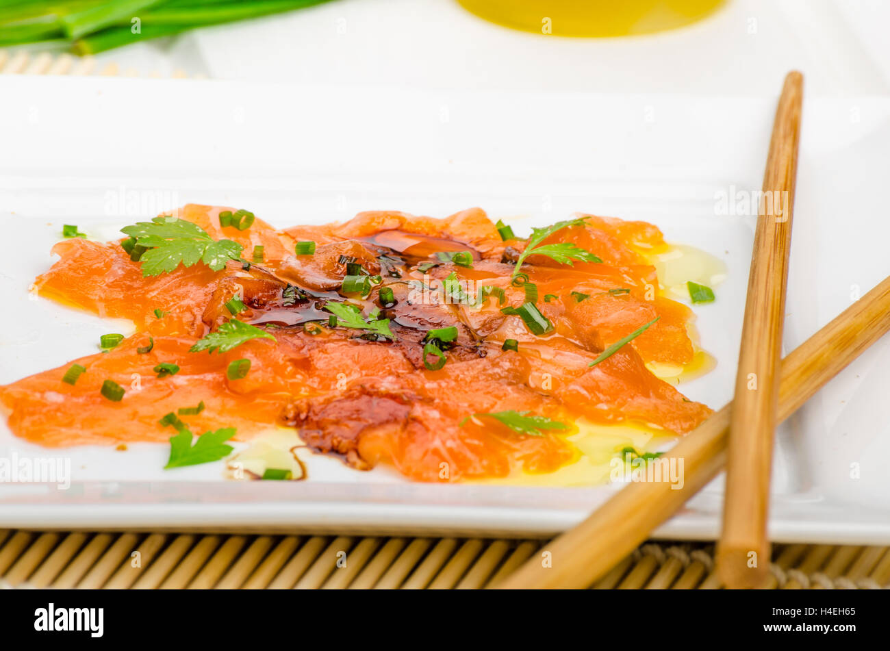 Sashimi new style - hot oil, herbs and soy souce Stock Photo - Alamy