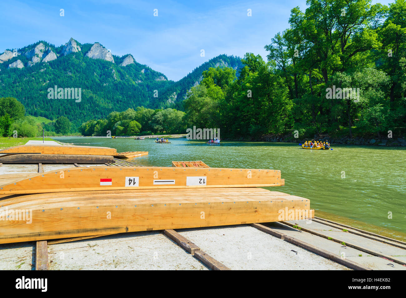 Wooden rafting boats on shore of Dunajec river and view of Trzy Korony ...