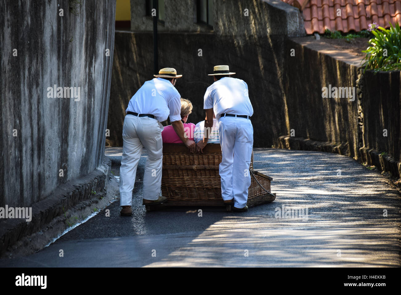Tourists traveling down the wicker basket toboggan basket ride, Monte ...