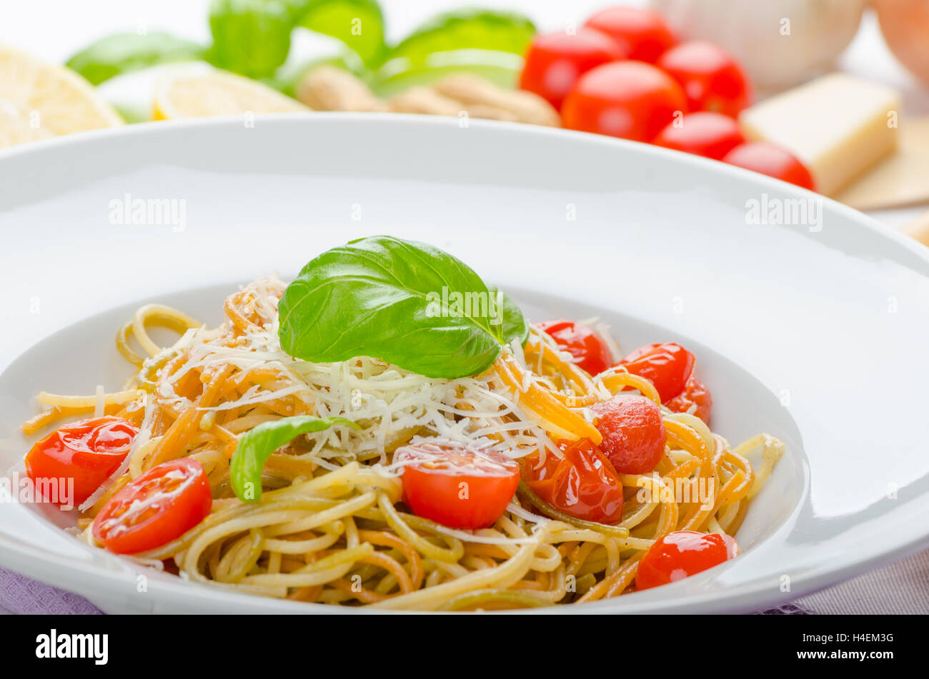 Lemon pasta with cherry tomatoes, basil and nuts, 2 plates, various ...