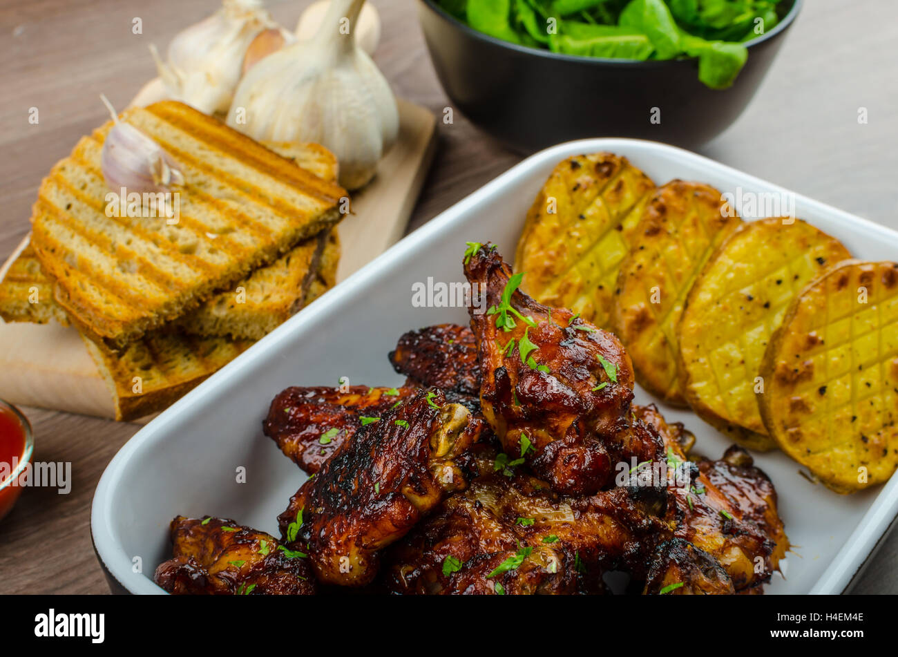 Sticky chicken wings with garlic bread panini, rustic spicy potatoes ...